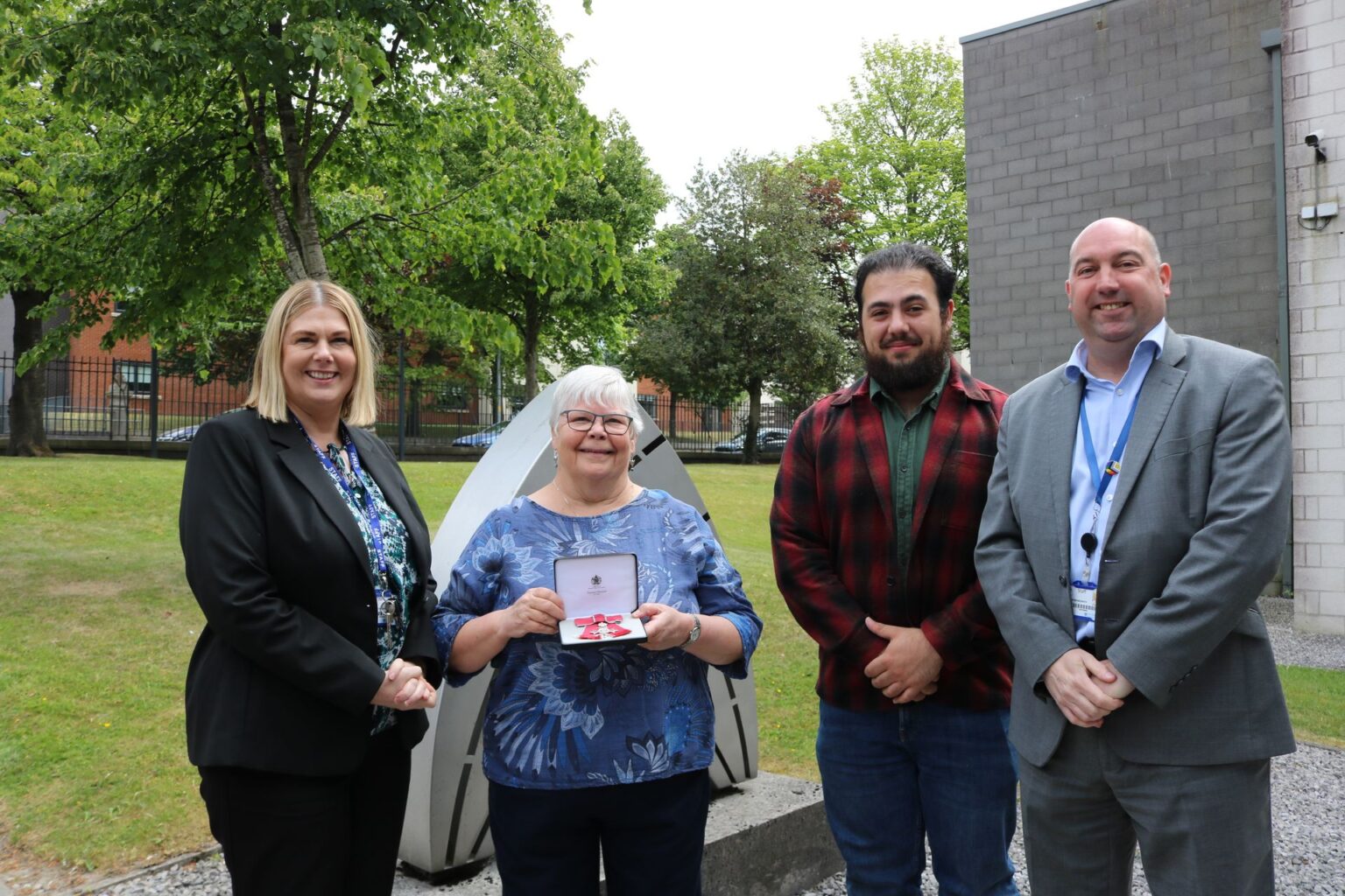 Former teacher honoured with MBE welcomed back to college - Tameside ...